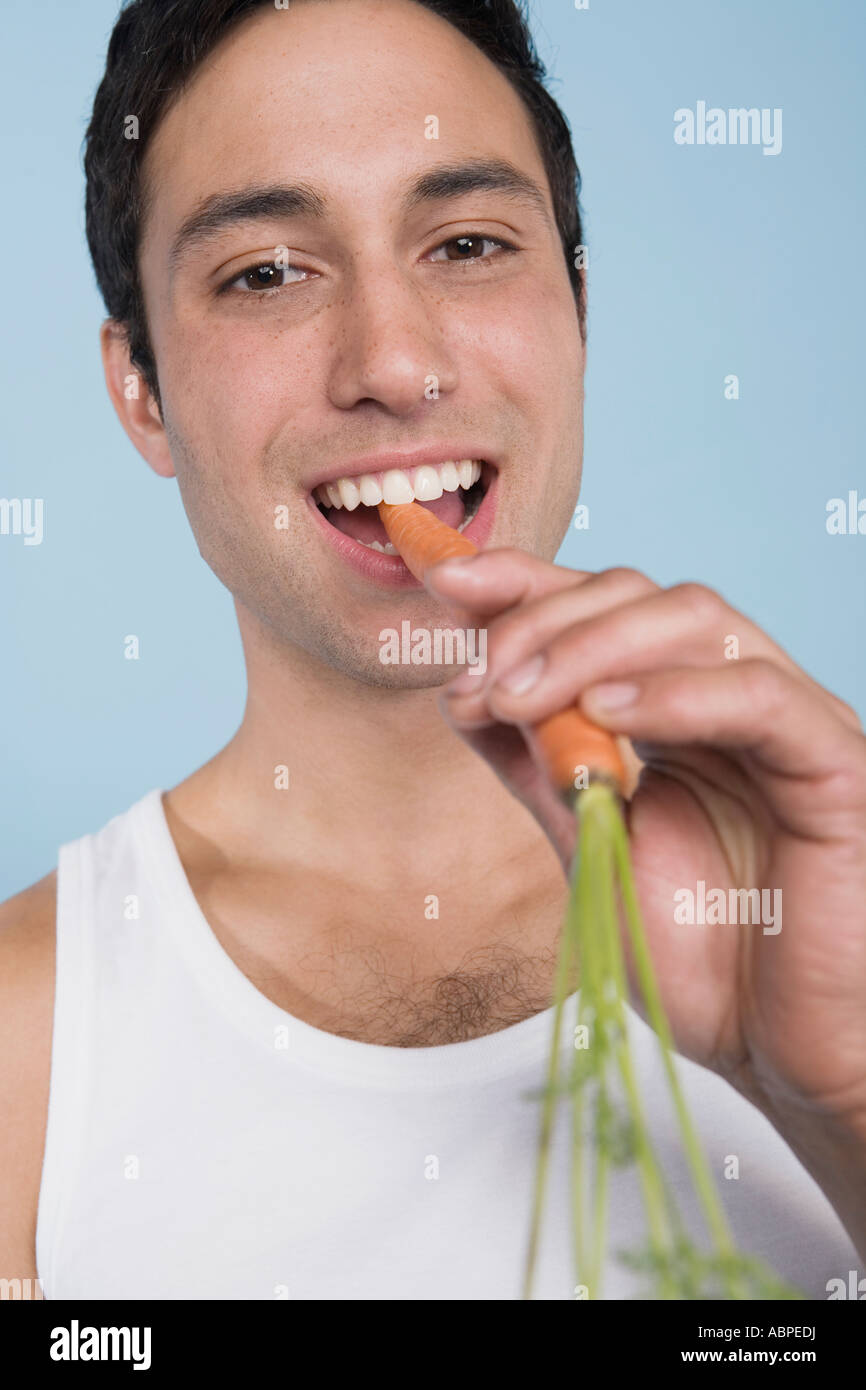 Man eating a carrot Stock Photo - Alamy