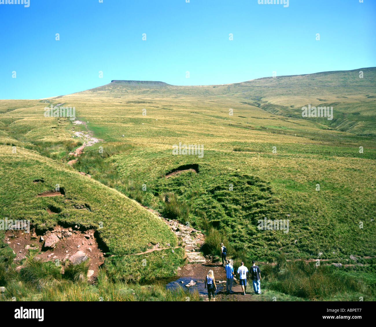 walkers on path leading to summit of corn du brecon beacons national ...