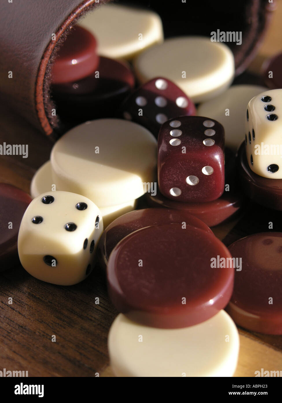Dice, shaker and draught game pieces Stock Photo - Alamy