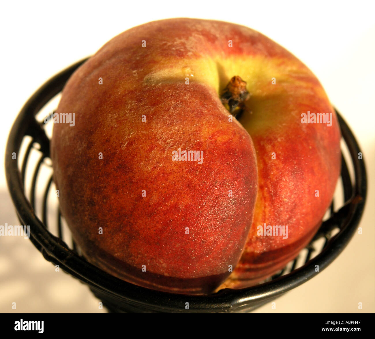 Whole peach fruit in a metal basket Stock Photo - Alamy