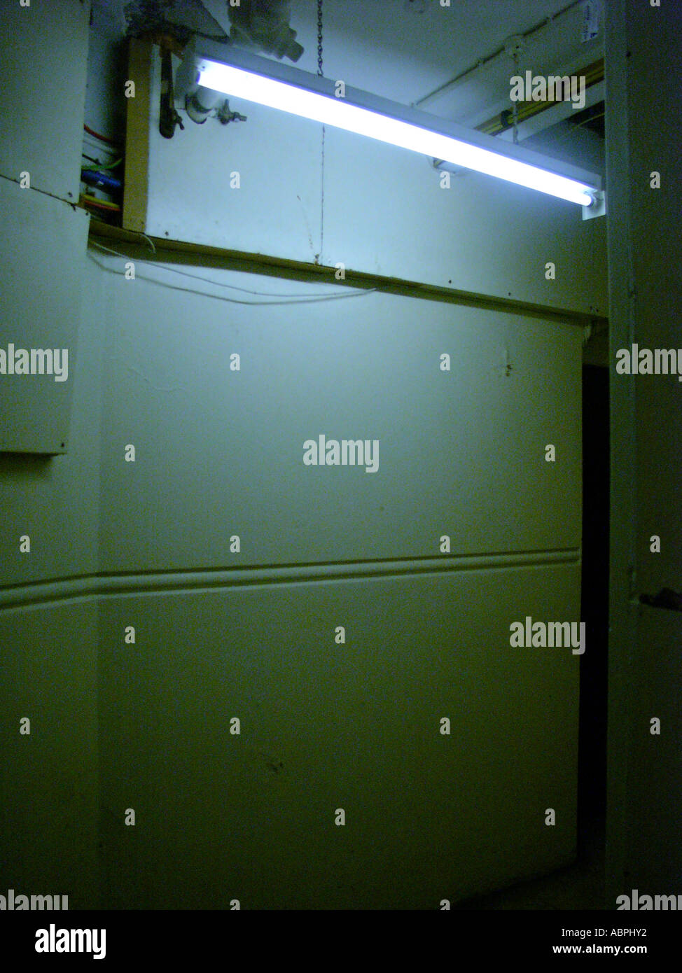 Fluorescent light glowing in an empty corridor room Stock Photo - Alamy