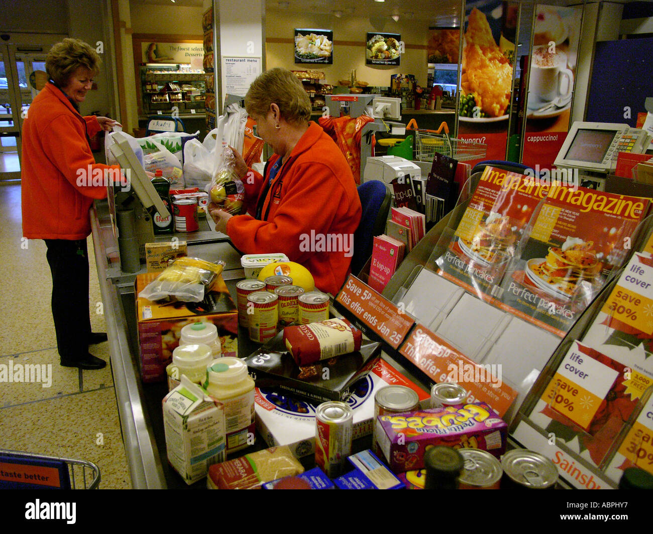 Woman at supermarket shopping checkout point buying enough food for an ...