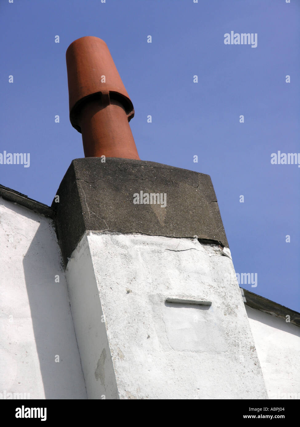 Teracotta Chimney pot on a tall brick chimney Stock Photo - Alamy