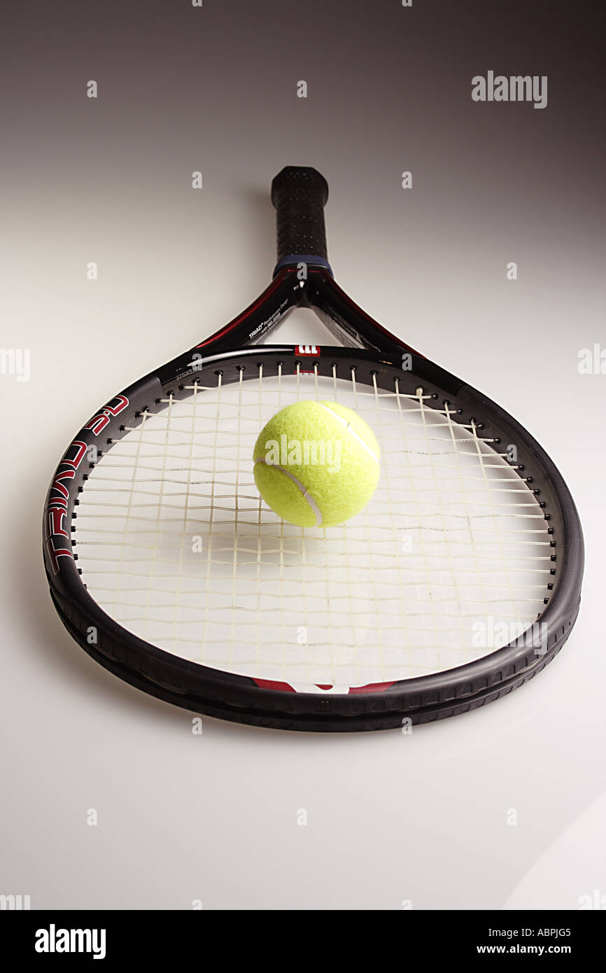VDA78931 Tennis ball one green color with racket Stock Photo - Alamy
