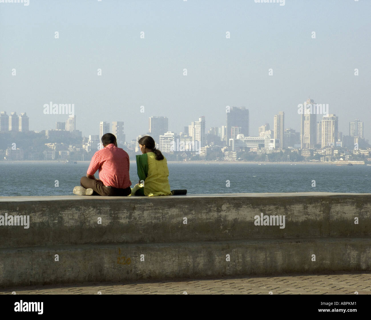 Couple sitting on Marine Drive parapet wall Bombay now Mumbai ...