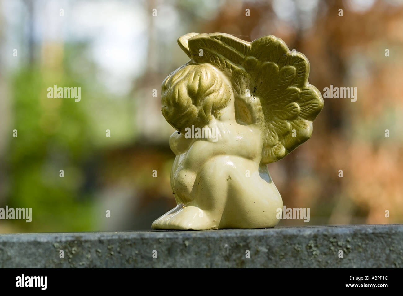 small angel statue on a grave Stock Photo - Alamy