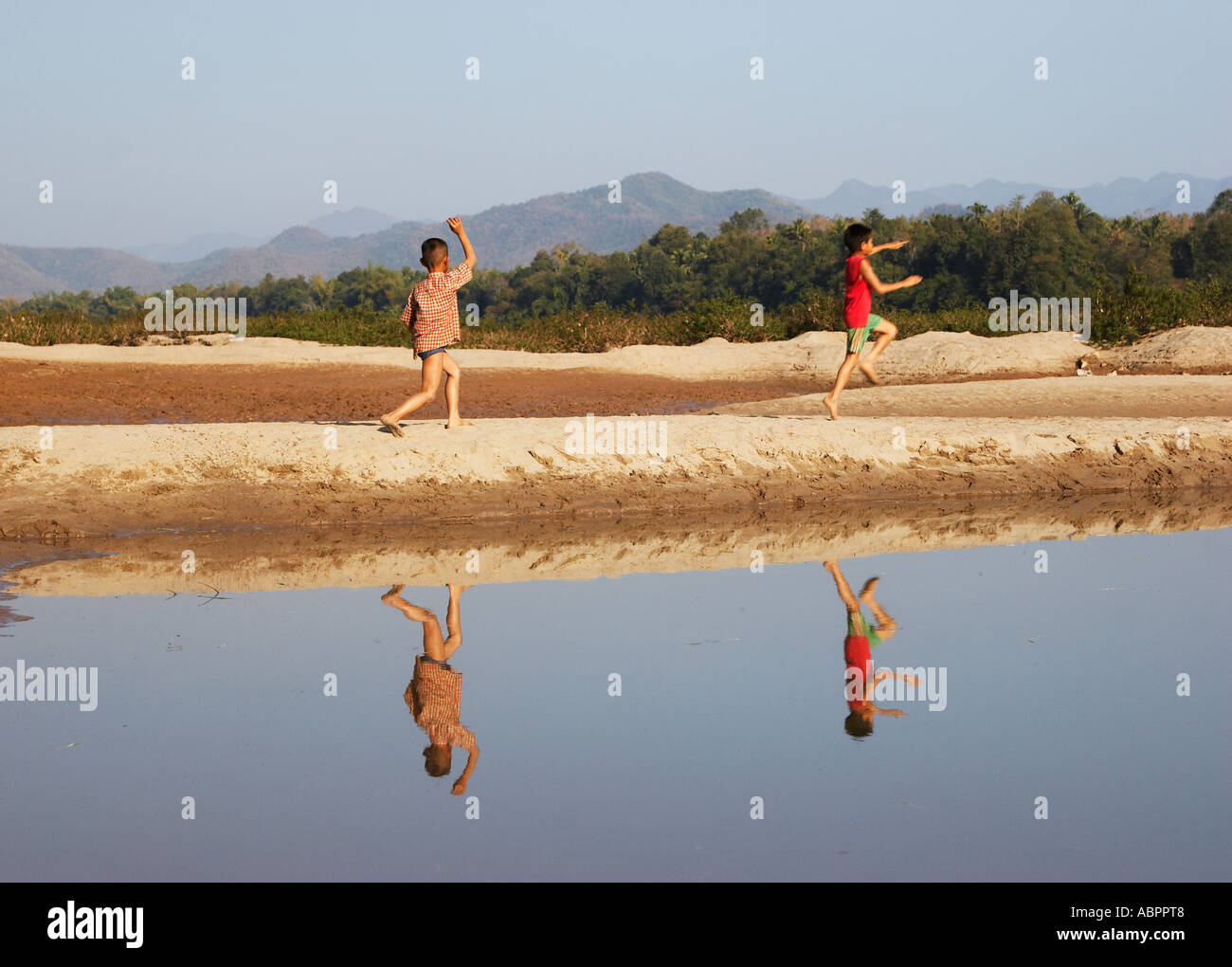 Boys Running Alongside Mekong River Stock Photo - Alamy