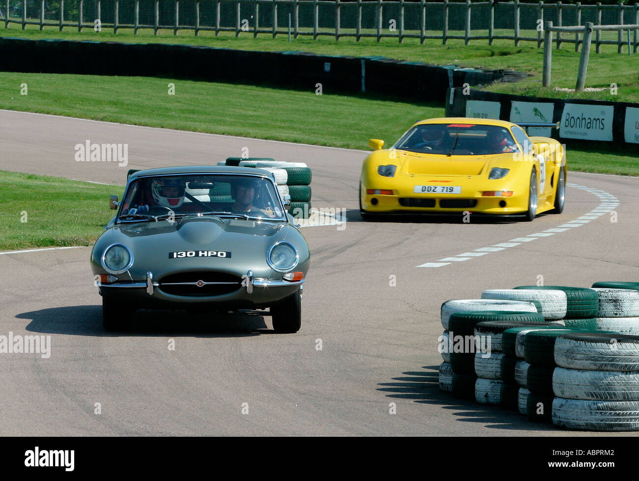 Jaguar E-Type is followed by a GTD R42 through the Goodwood Motor ...