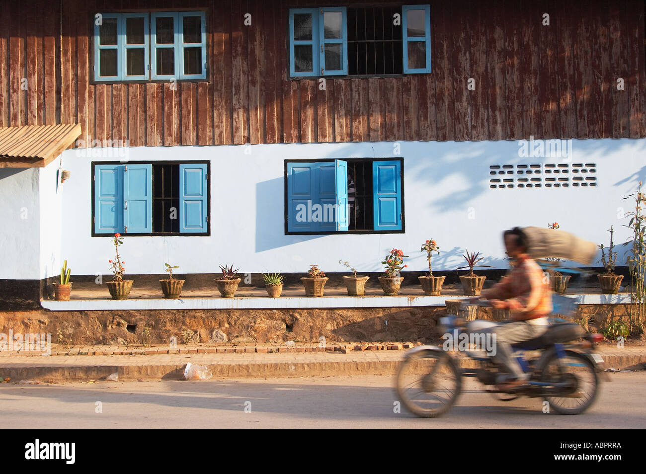 Motorcycle Passing Colonial Building Stock Photo - Alamy