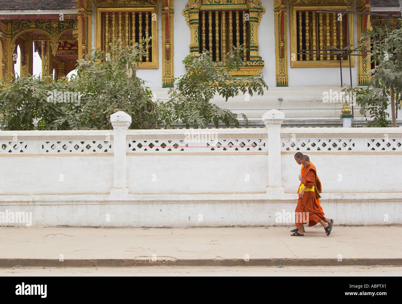 Two buddhist monks walk along road hi-res stock photography and images ...