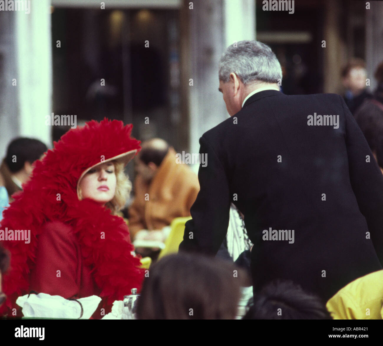 Waiter and carnival time customer at a café in St Mark's Square Venice ...