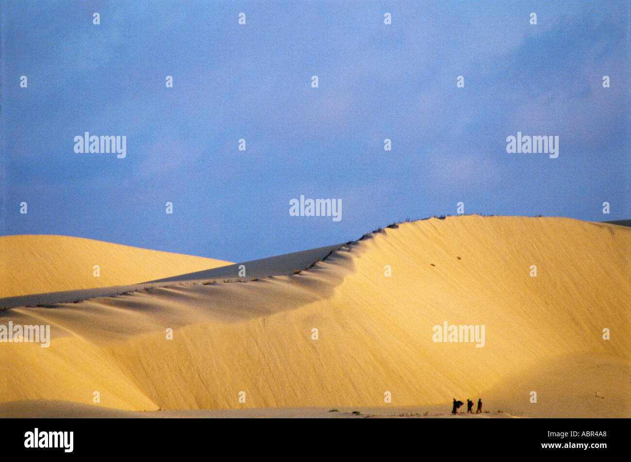 Fortaleza, Brazil. Sand dunes at Praia do Cumbuco with three people ...