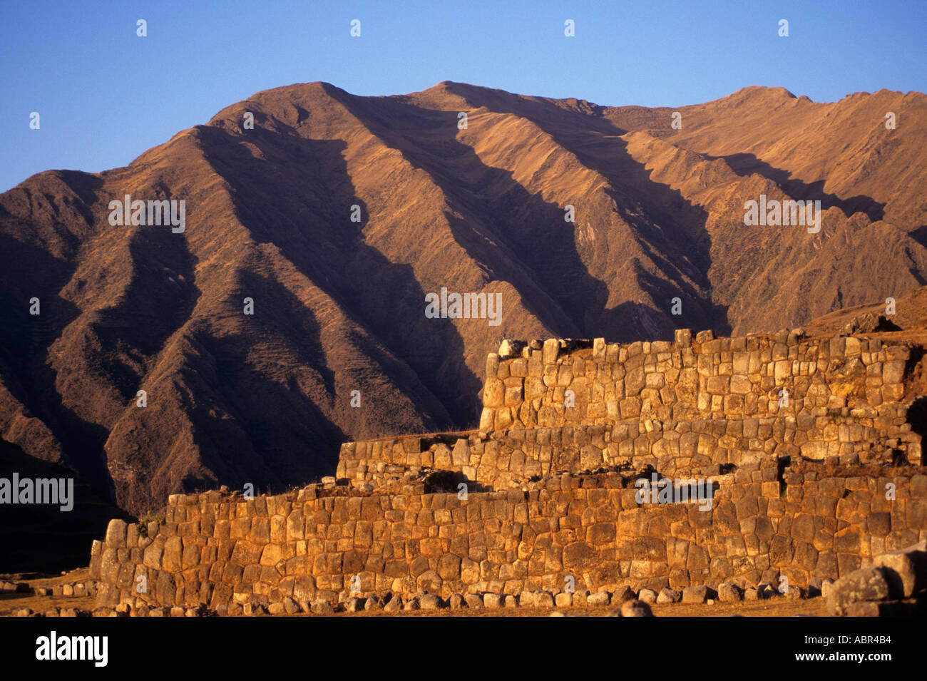 Chinchero, Peru. Inca masonry stone walls with deeply eroded mountains ...
