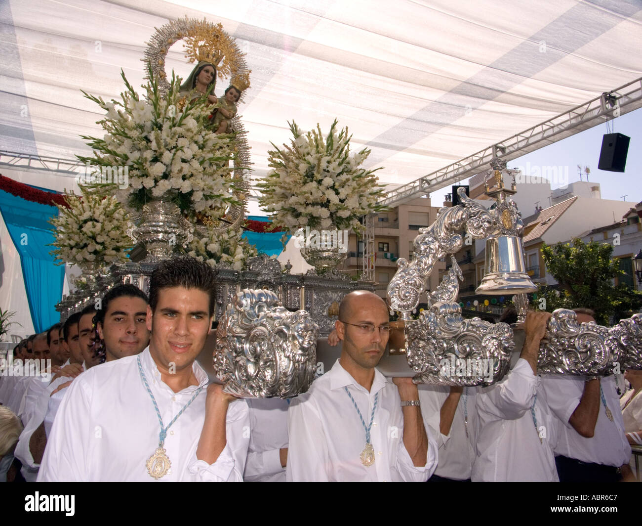 Throne of the Virgin Mary being carried by throne bearers, costaleros ...