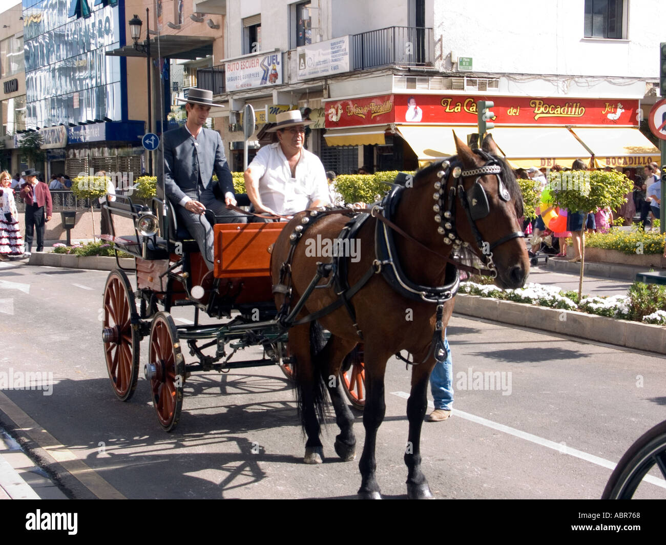 Spanish People in Traditional Costumes riding in an open horse drawn ...