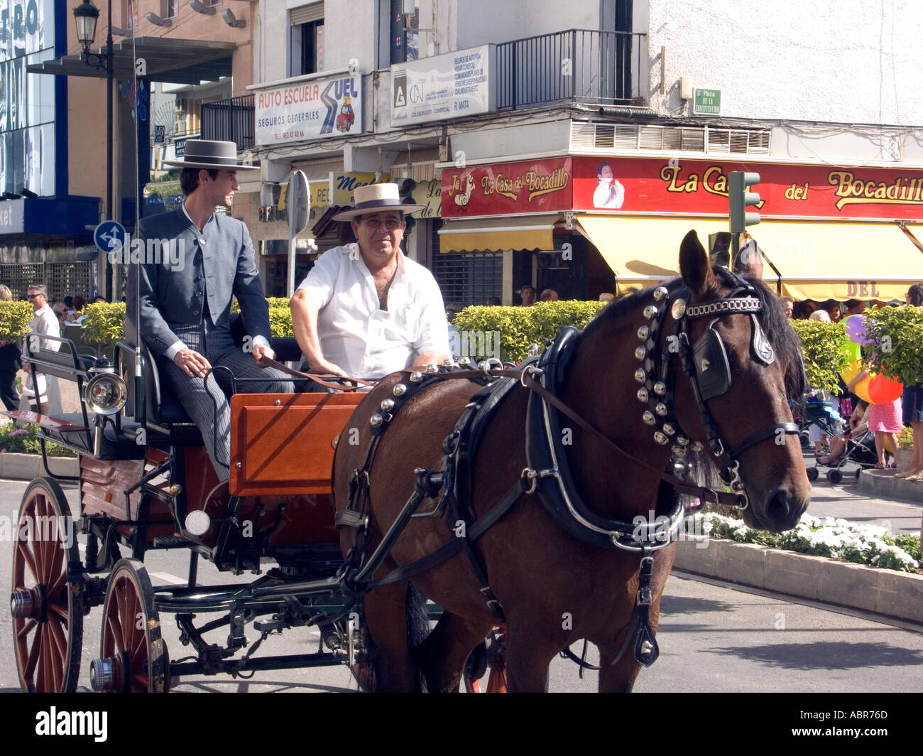 Spanish People riding in an open horse drawn carriage at the Fuengirola ...