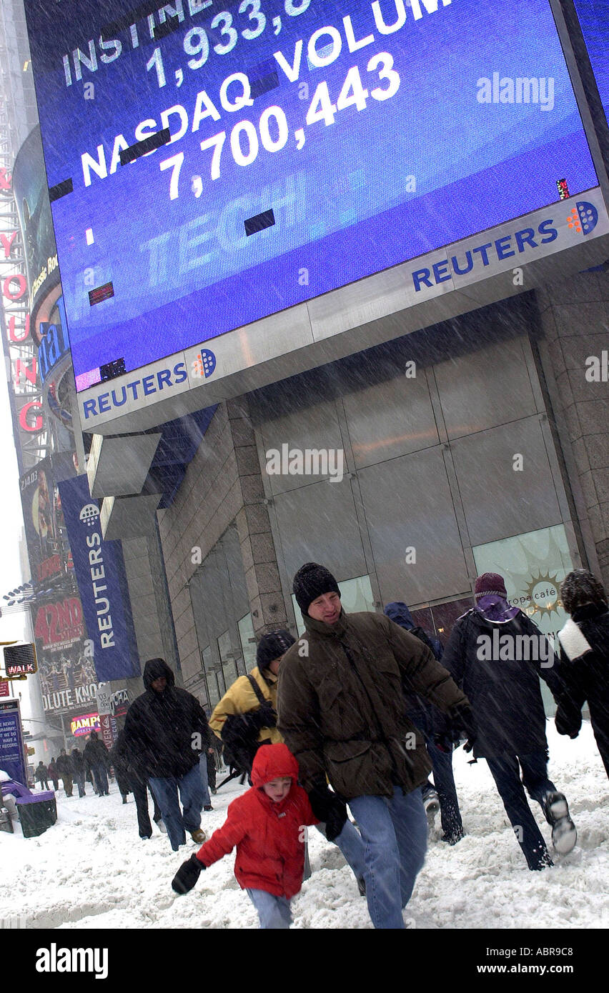 Visitors to Times Square maneuver through the snow in front of the ...