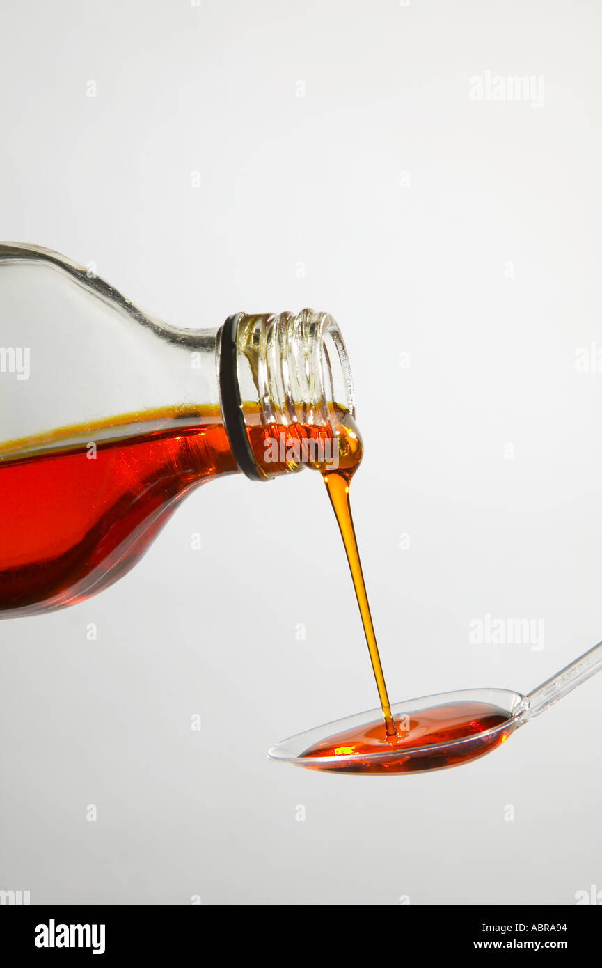 MEDICINE POURING FROM BOTTLE INTO PLASTIC SPOON Stock Photo - Alamy