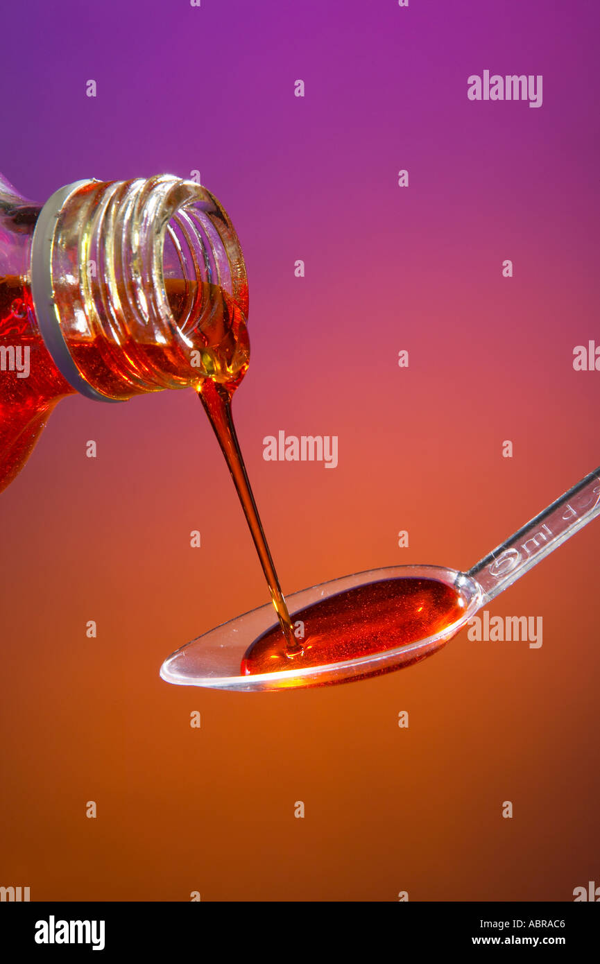 MEDICINE POURING FROM BOTTLE INTO PLASTIC SPOON Stock Photo - Alamy