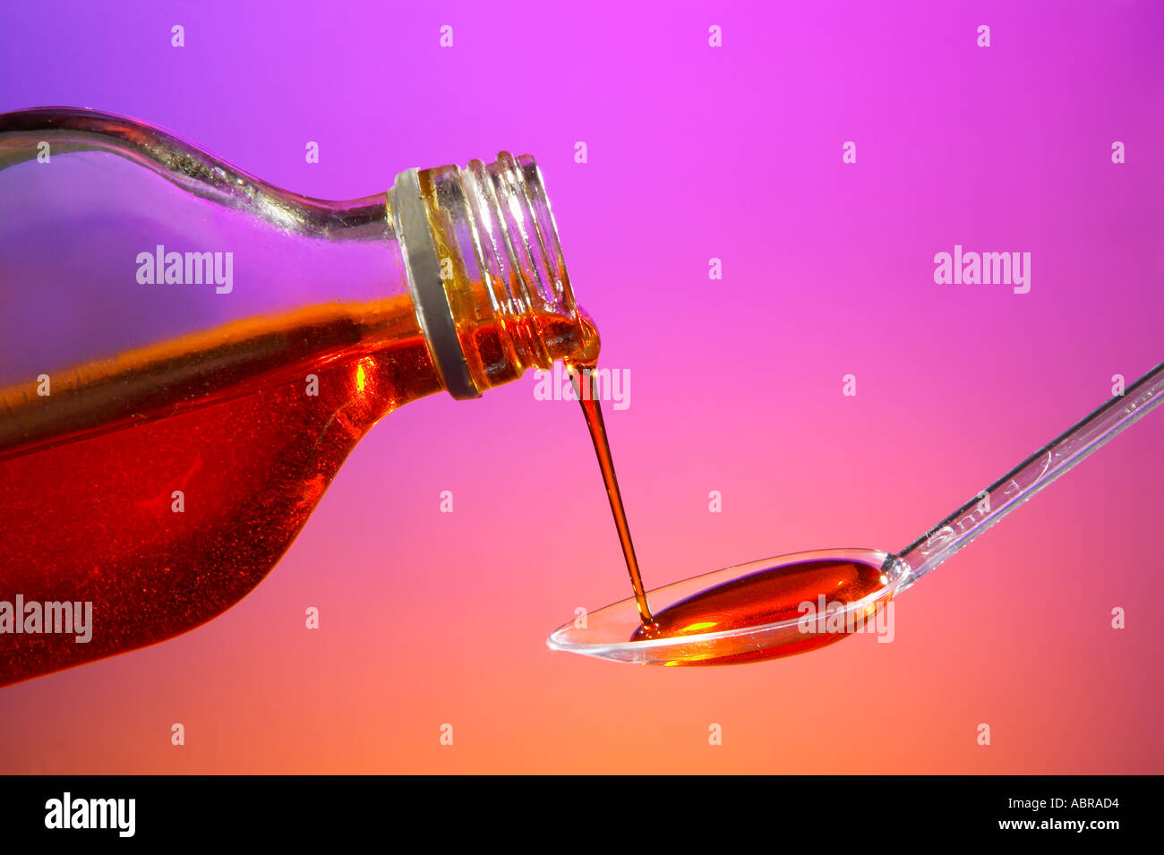 MEDICINE POURING FROM BOTTLE INTO PLASTIC SPOON Stock Photo - Alamy