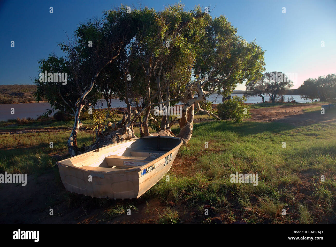 Small tinnie aluminium hull boat on the shores of the Murchison River ...