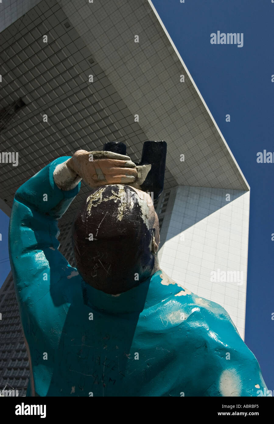 Grande Arche de la Defense plaster man with binoculars looking up at ...