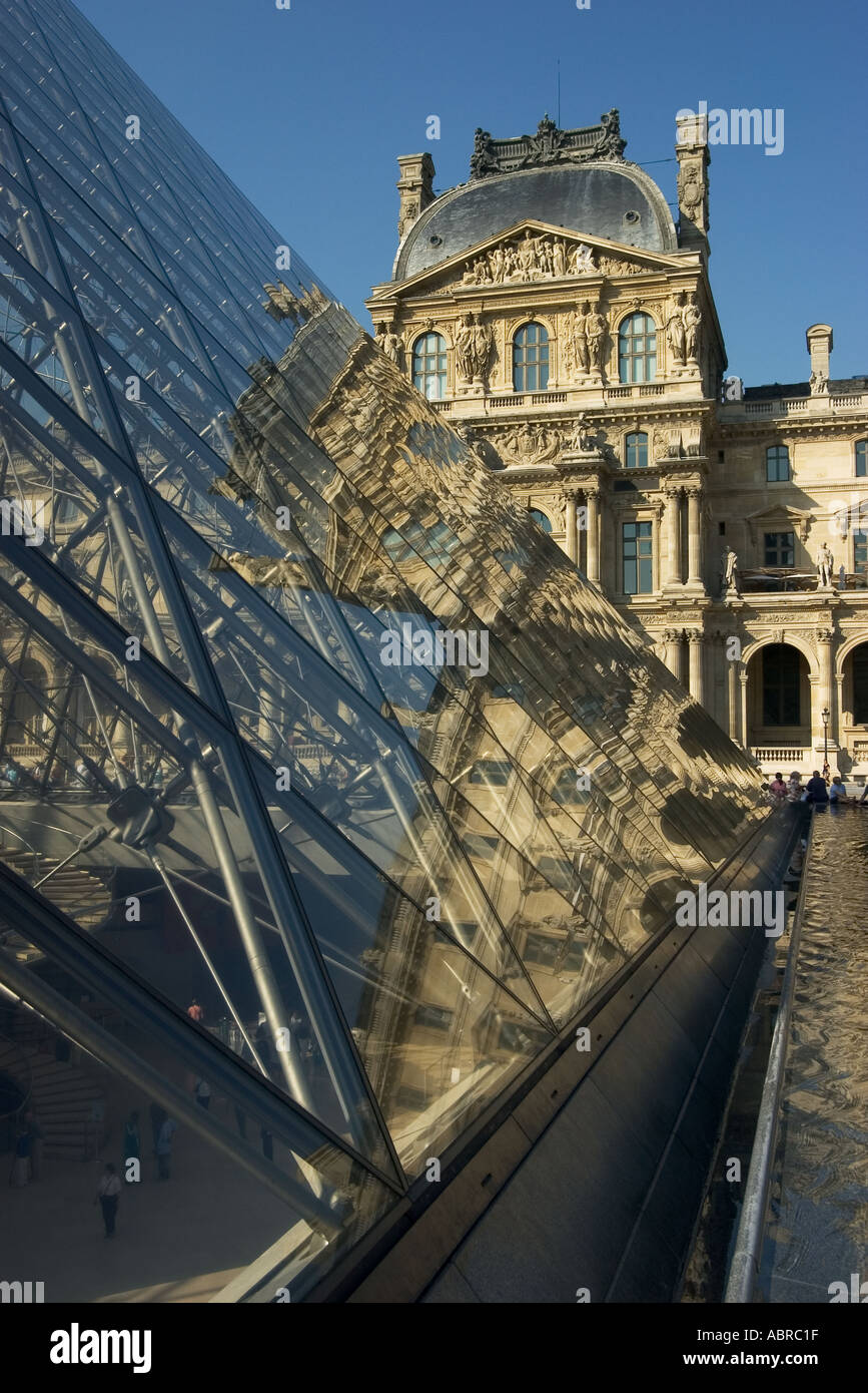 Louvre Paris and reflections in the large Pyramid visitors to the ...