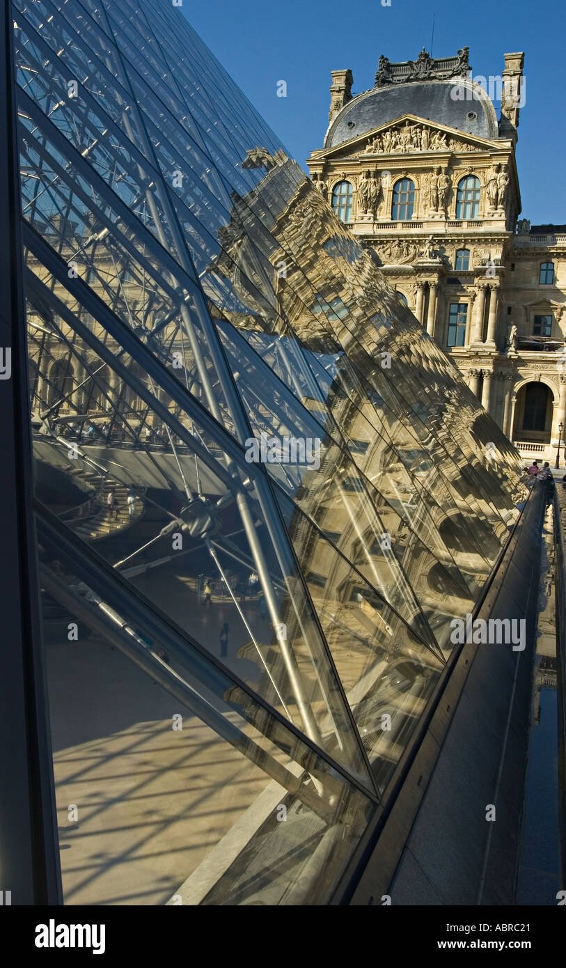 Louvre Museum Paris and reflections in the large Pyramid with shadow in ...