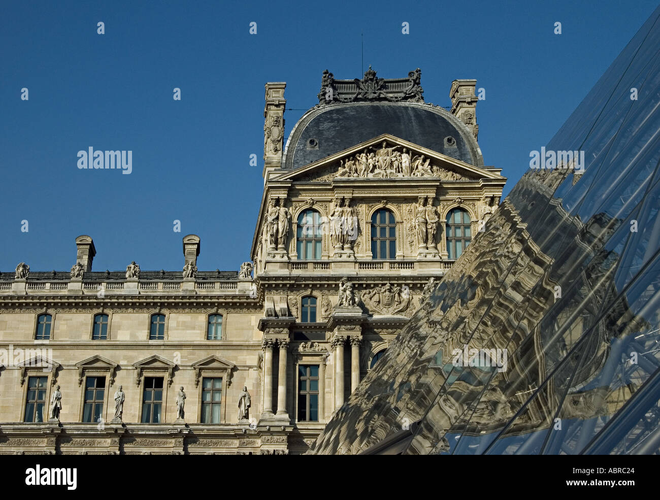 Louvre Paris and reflections in the large Pyramid visitors to the ...
