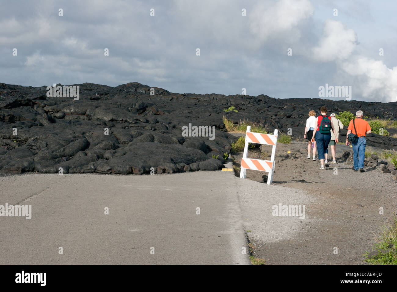 Tourists walk out onto pahoehoe lava, to view the fresh magma as it ...