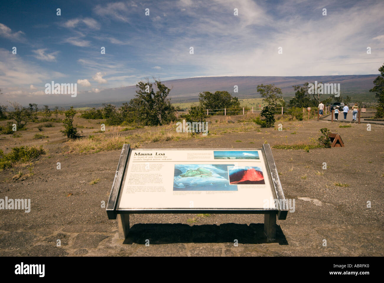 A snow capped Mauna Loa with sign: In front of you looms the world's ...