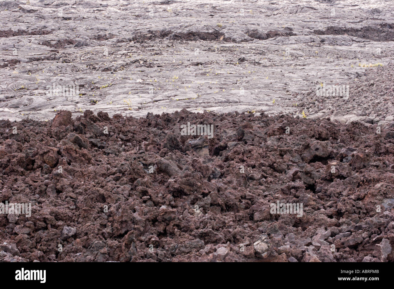 Rubbly a'a lava flow over smooth, almost glassy, pahoehoe flow (behind ...