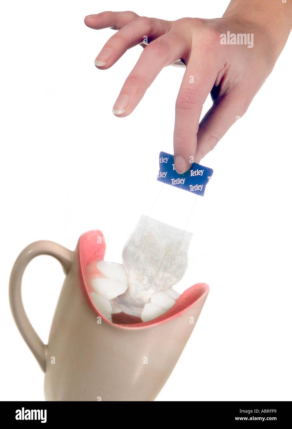 Tea Bites Back, A mug with Teeth Attacks Hand Stock Photo - Alamy