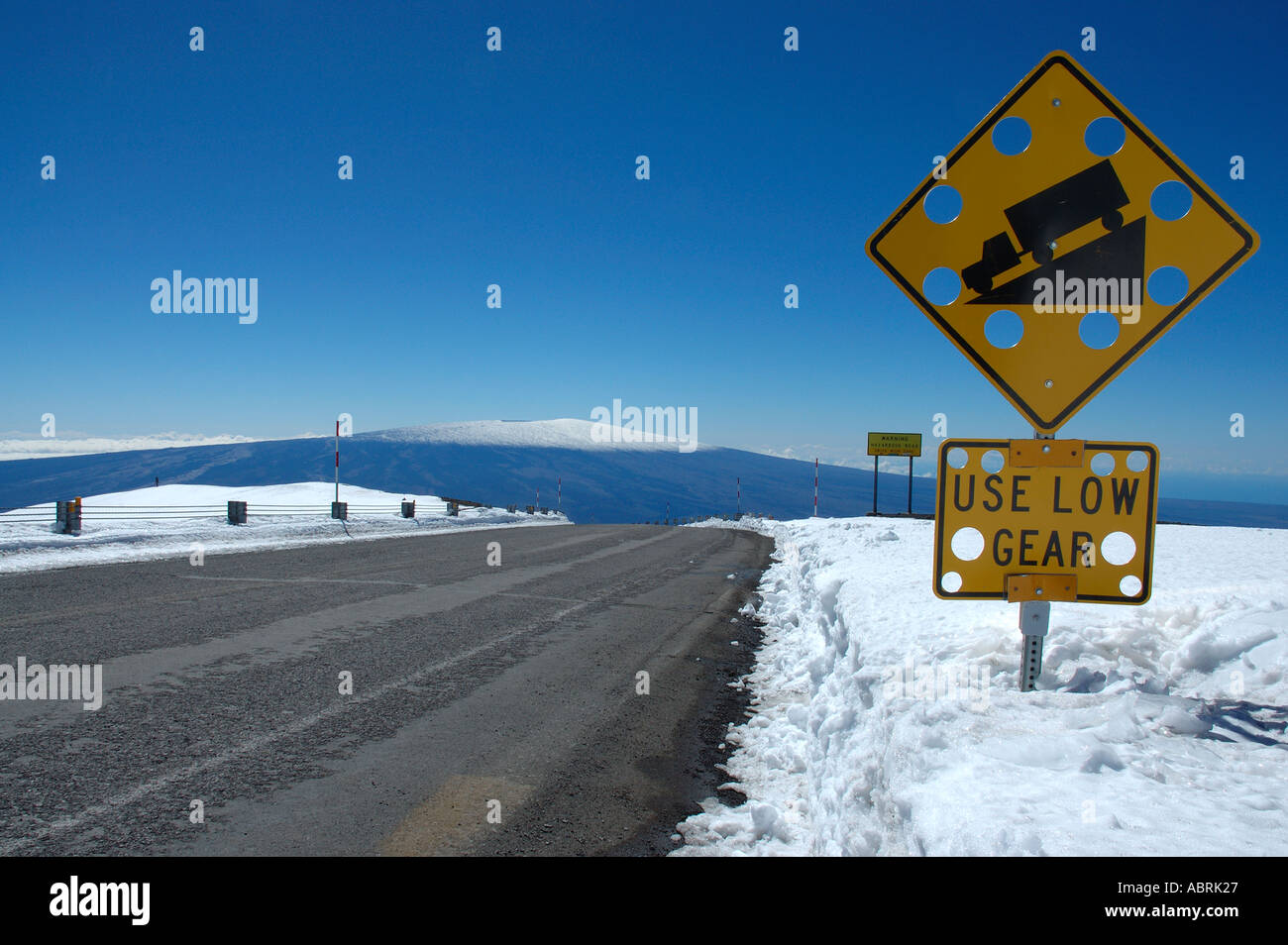 Access road and warning signs Mauna Loa in the distance Mauna Kea The ...