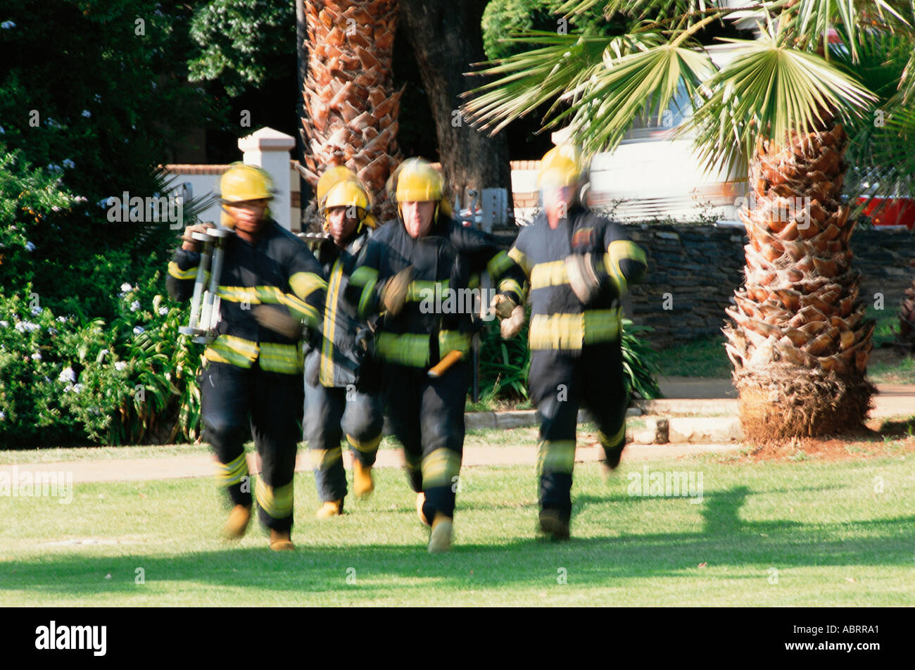 Firemen running to an emergency Stock Photo - Alamy