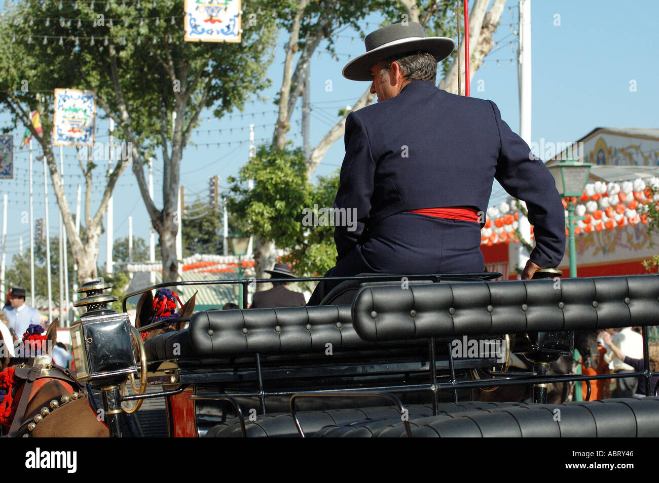 Coachman in traditional dress driving through the April Fair Seville ...