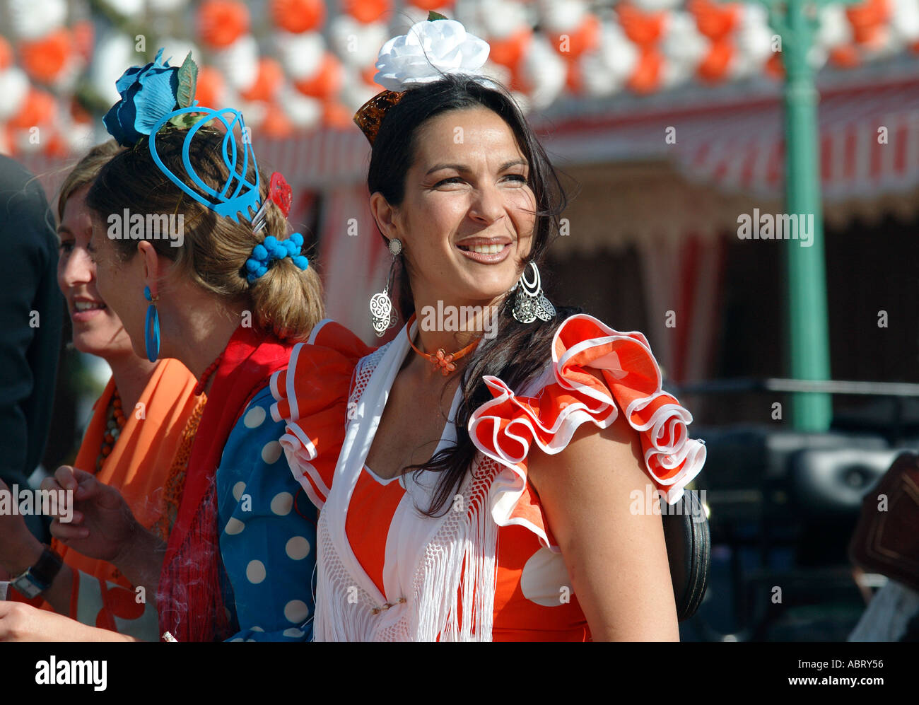 Girls in flamenco dresses riding in a horse carriage at the April Fair ...