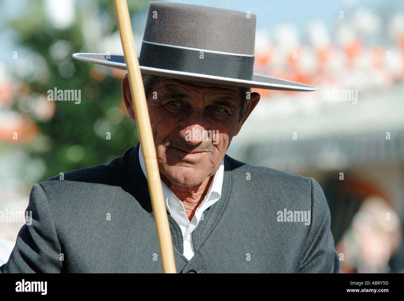 Portait of an old coachman in traditional dress with a whip at the ...