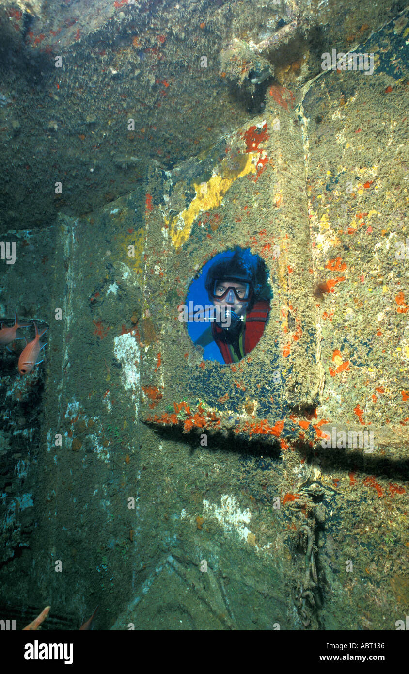 Diver Looking Inside Porthole of Sunken Shipwreck Stock Photo - Alamy