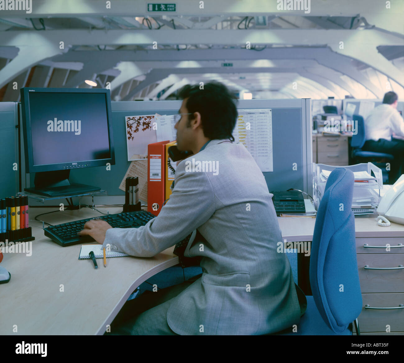 Office life and interiors. Office worker on the phone at his desk Stock ...