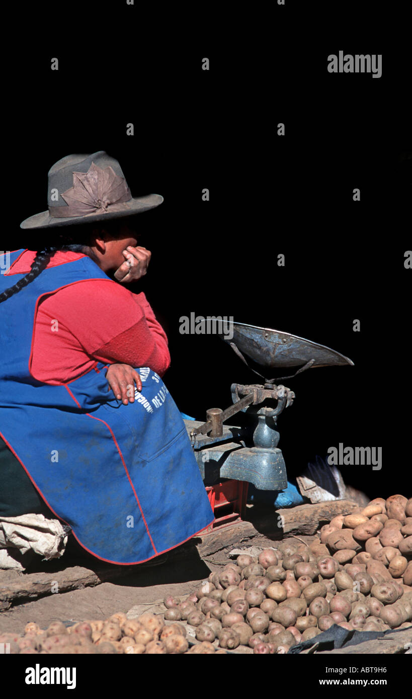 PERU A seated street market potato vendor from Huaraz Northern Peru ...