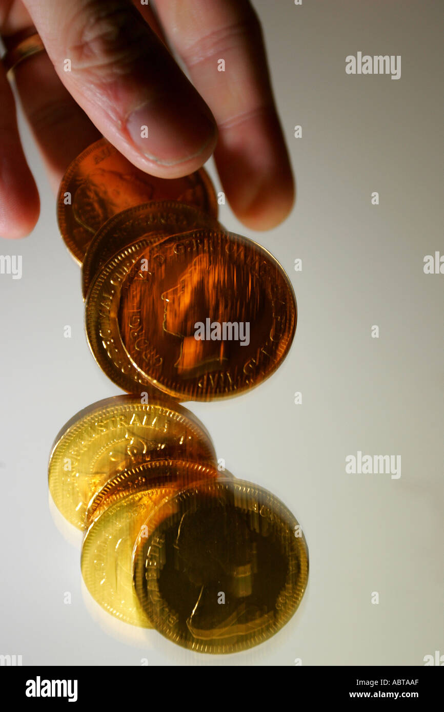 Money falling from hand Stock Photo - Alamy