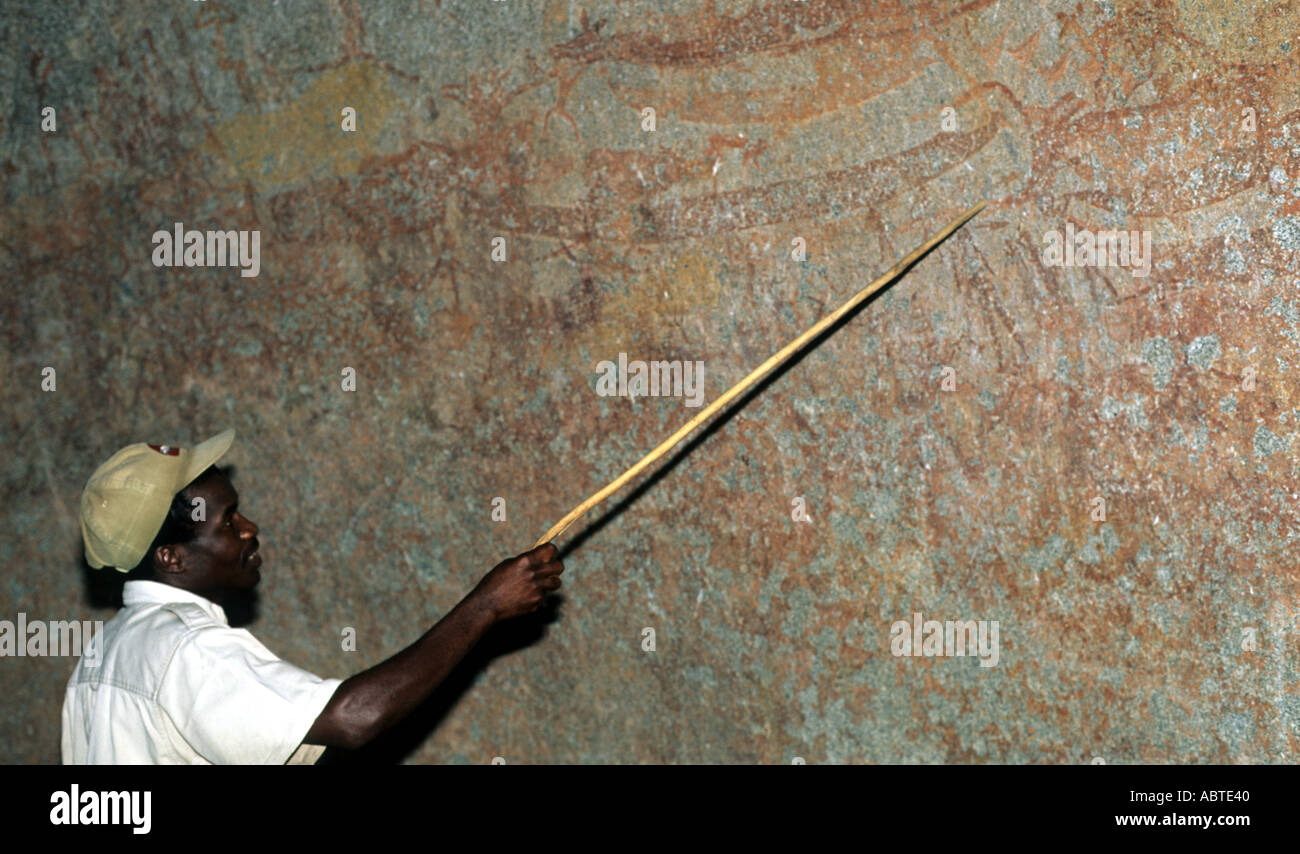 Guide points out rock art in Matopos National Park Zimbabwe Stock Photo ...