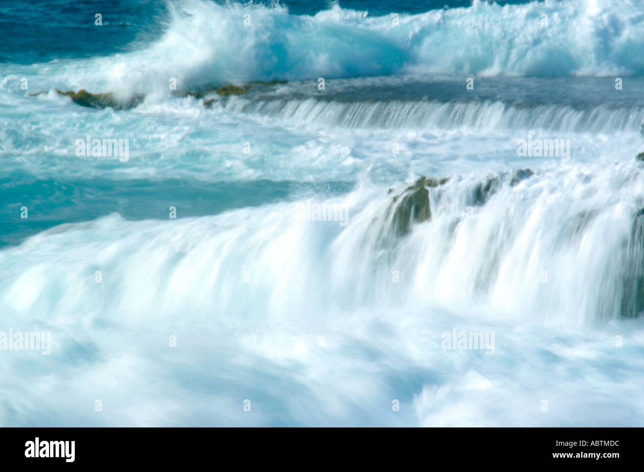 Raging waters run over rocks in the ocean located at Sharks Cove North ...