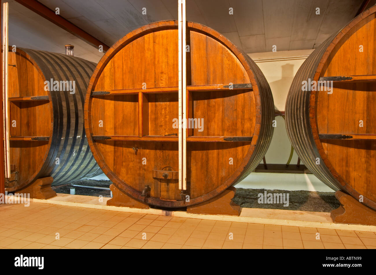 A storage room in the winery with old wooden foudres (large wooden ...