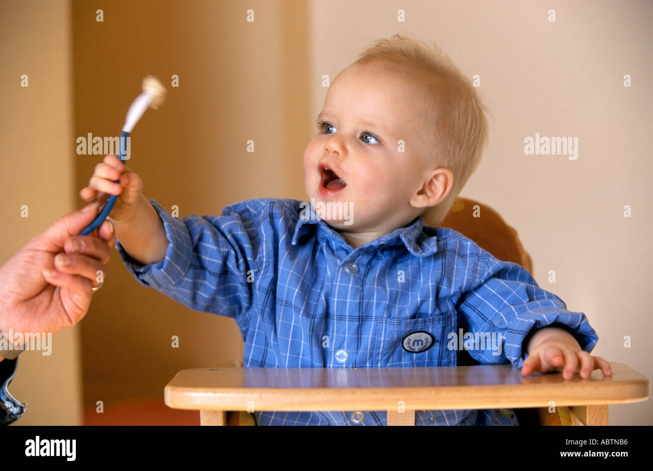 Toddler eating with a plastic fork Stock Photo - Alamy