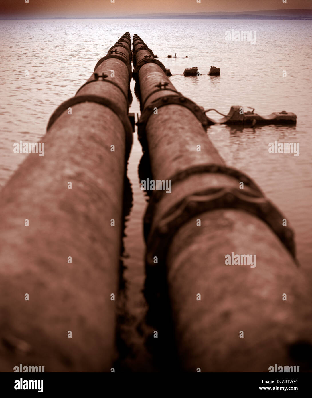 Vertical colour picture of steel pipes leading into a river Stock Photo ...