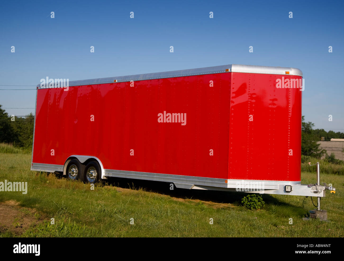 Red trailer in a field Stock Photo - Alamy