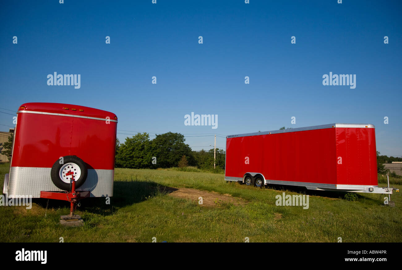 Red trailers in a field Stock Photo - Alamy