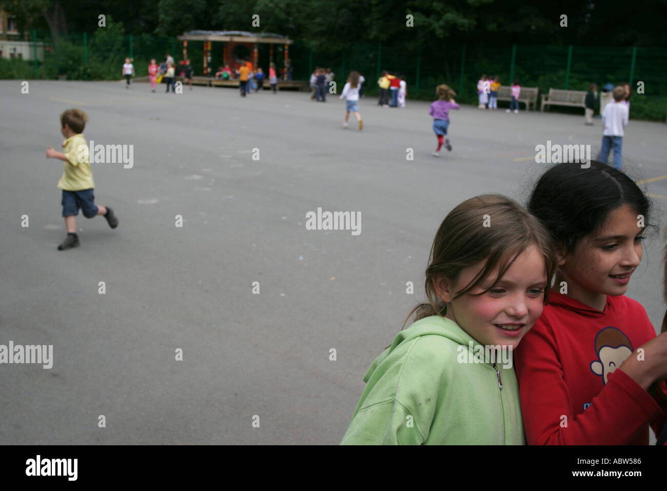Two friends playing together and laughing in the playground, Betty ...